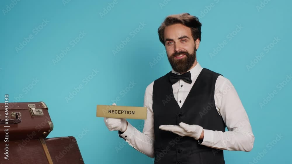 Hotel staff uses reception indicator on camera, guiding people in the ...