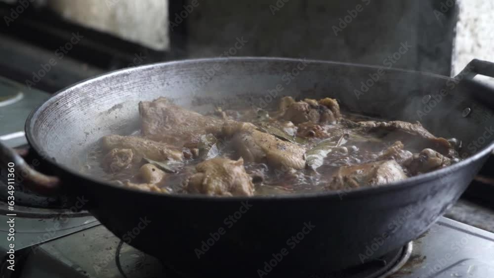 Medium shot of Chicken Adobo being cooked. Adobo is a popular Filipino ...