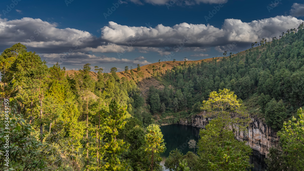 A beautiful lake in the crater of an extinct volcano is surrounded by ...
