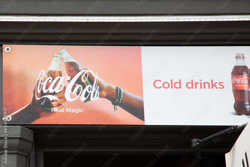 Coca Cola real magic sign brand and english text logo on panel facade ...