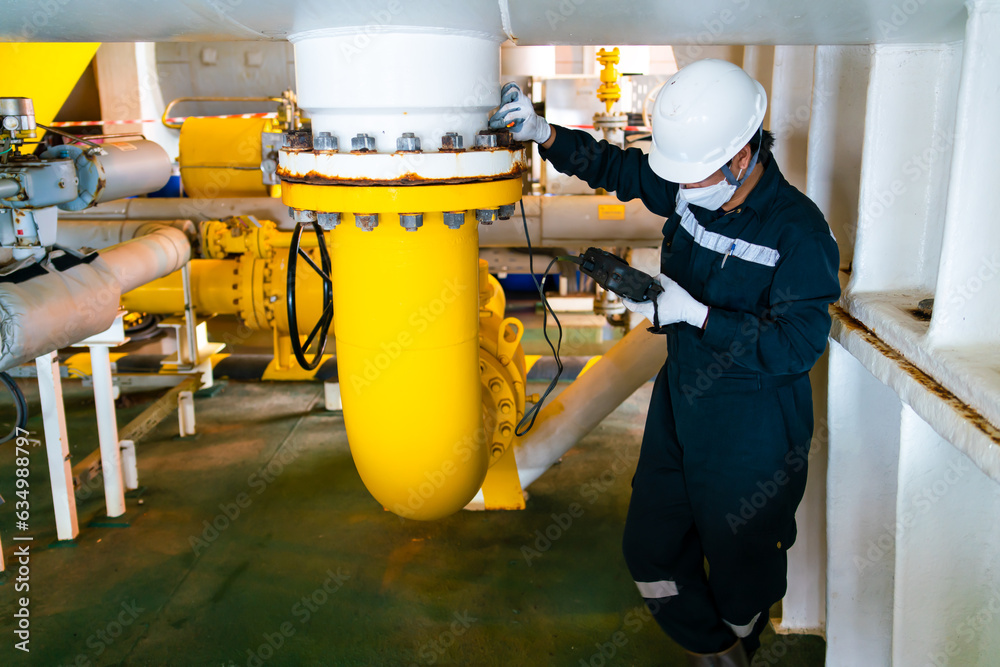 Non-destructive testing technicians are checking the thickness of elbow ...