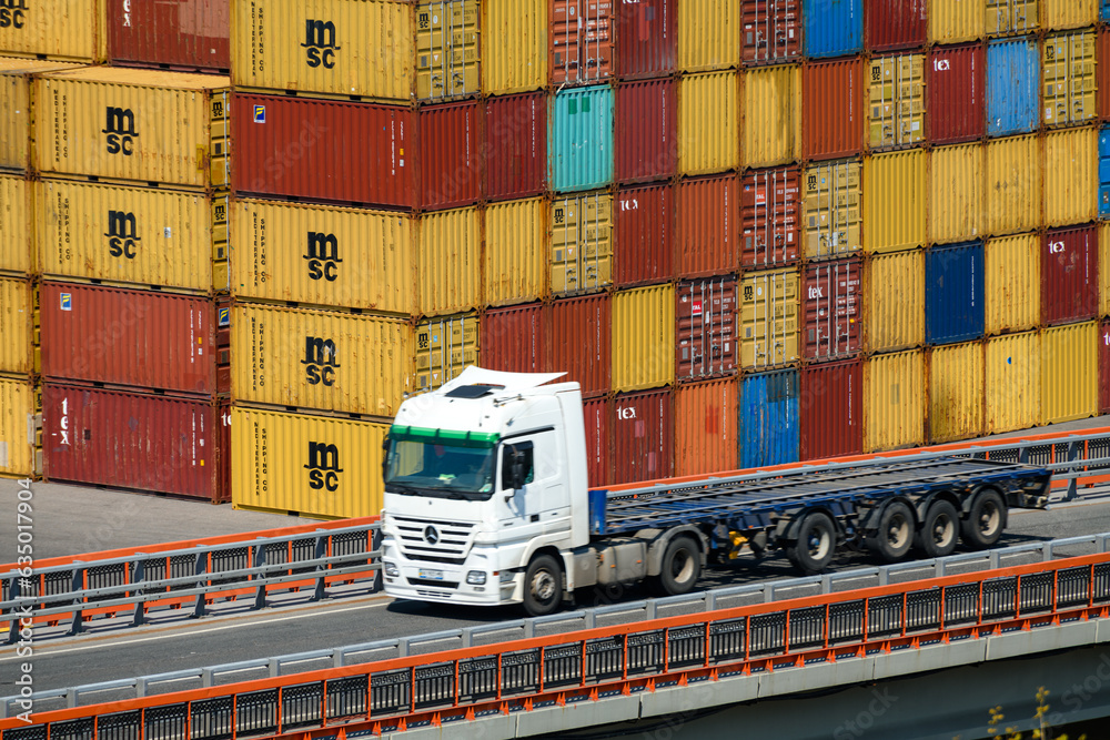 seaport, truck transports container through industrial seaport ...