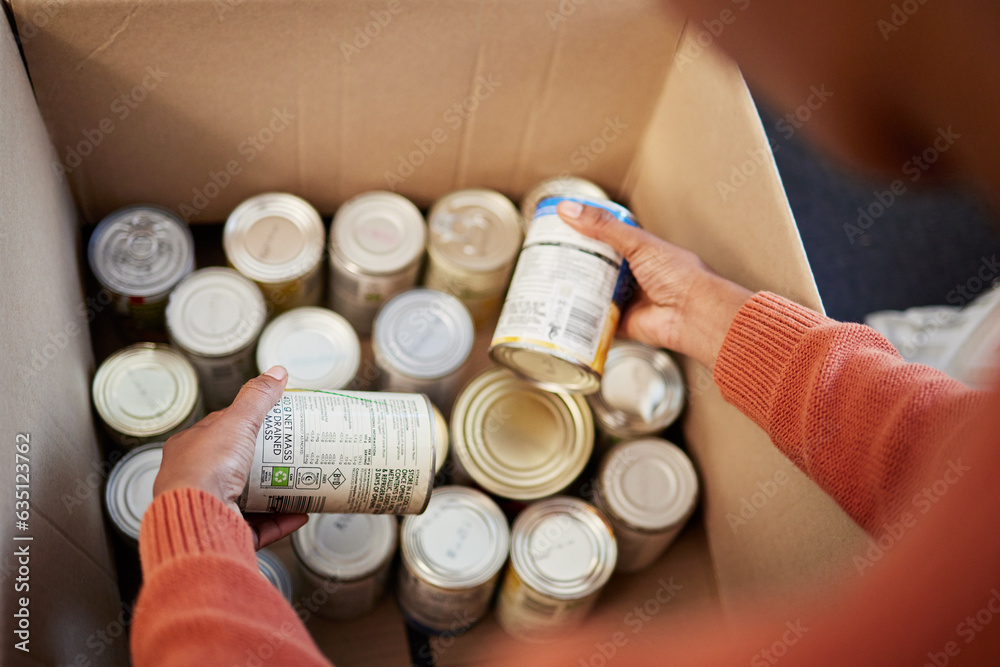 Donation, food in cans in box and hands of man checking stock, decision ...
