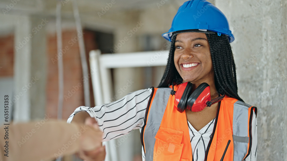 African american woman builder smiling confident shake hand at ...