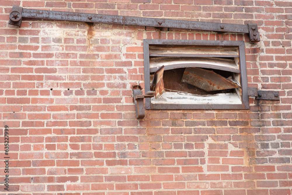Remnants of an antique, industrial fire door on the exterior of a red ...