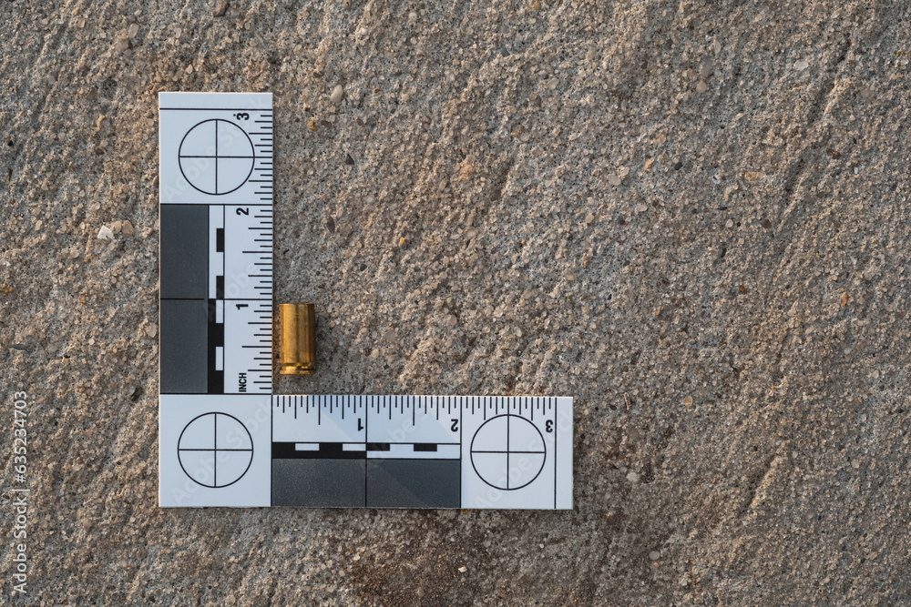 One crime scene evidence ruler on the street after a gun shooting brass ...