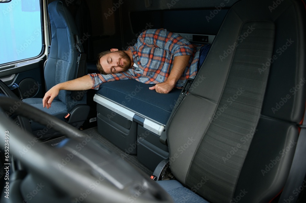 Truck driver sleeping on bed inside truck cabin interior. Trucker ...