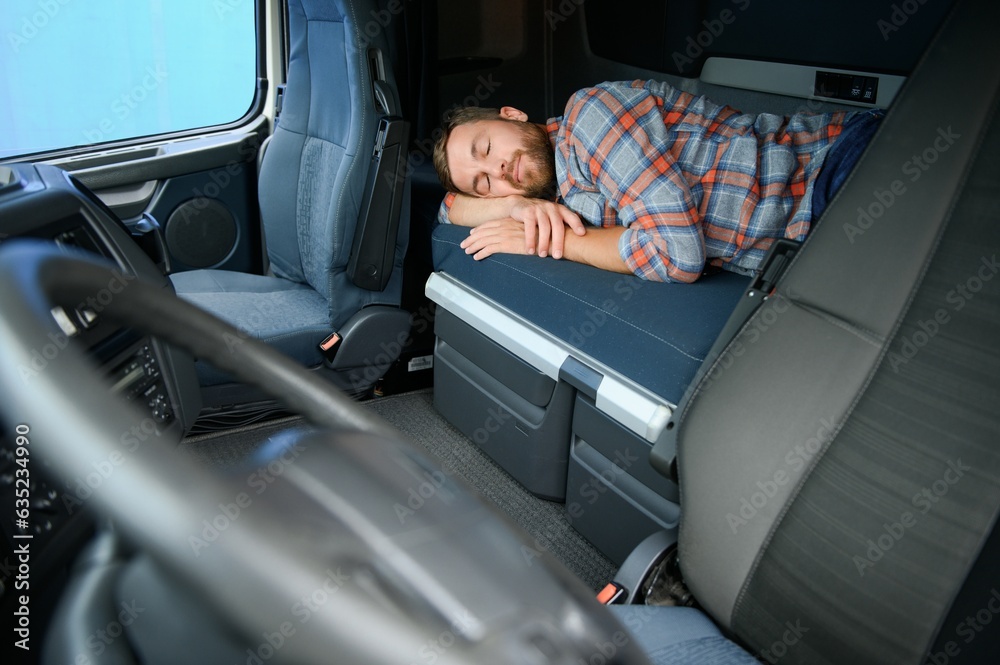 Truck driver sleeping on bed inside truck cabin interior. Trucker ...