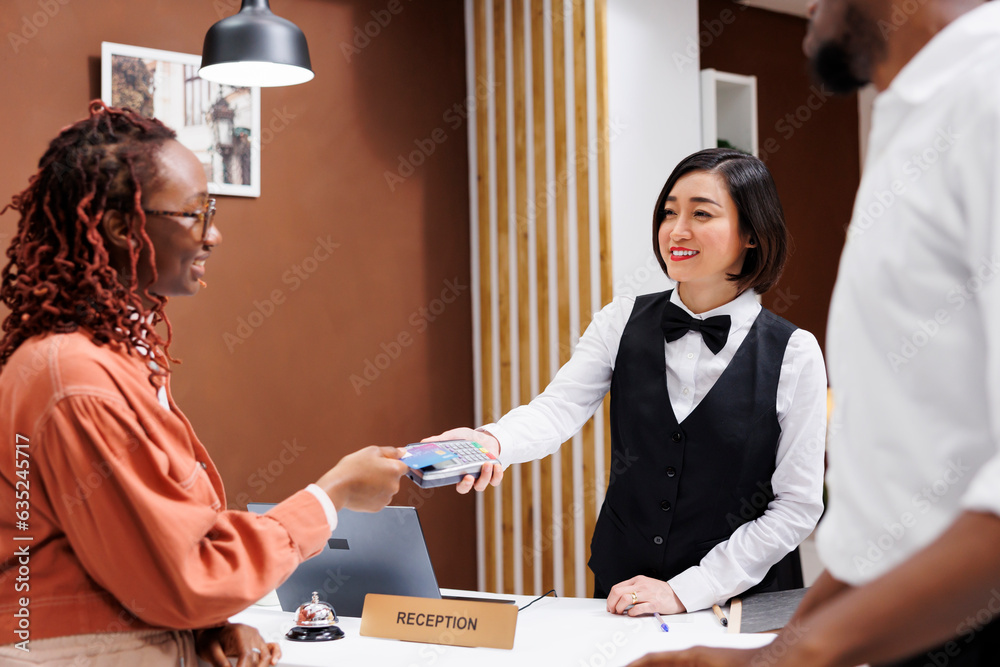 Guest paying for room service at counter, using credit card and pos ...