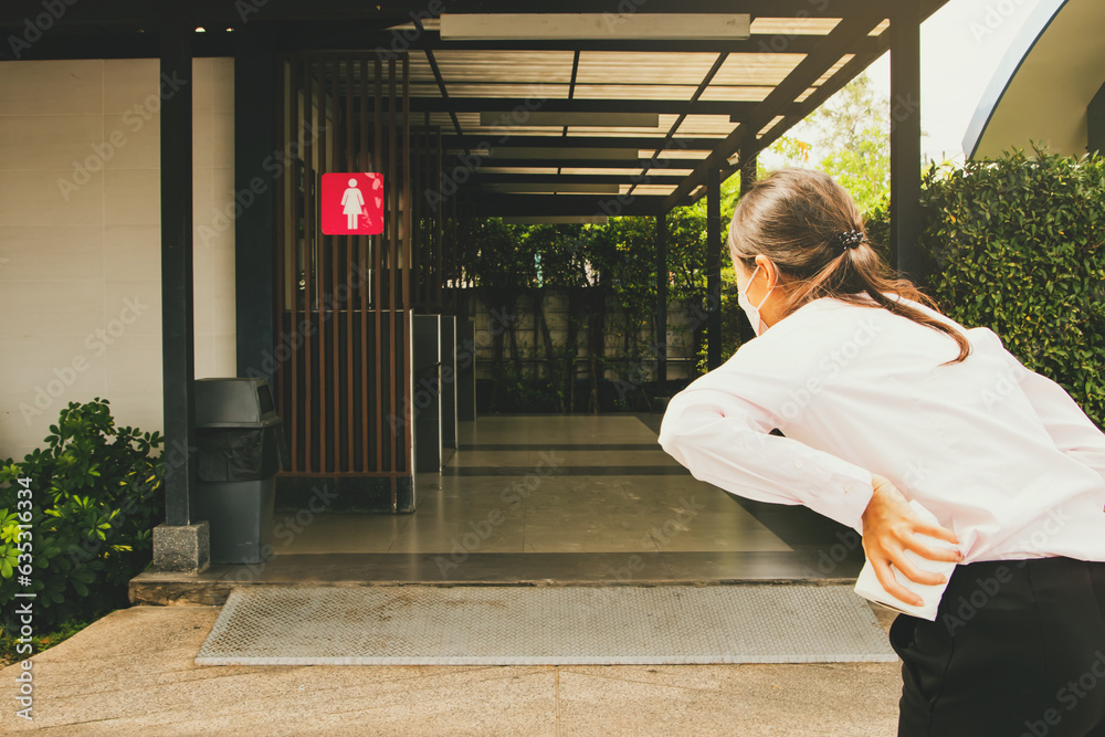Sick young woman walks hunched over, has severe abdominal pain ...
