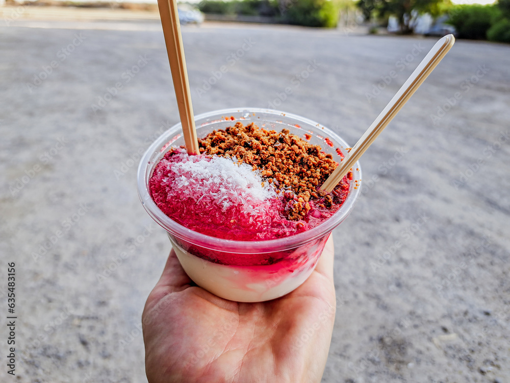 Milk Israeli dessert Malabi with peanuts, coconut and rose syrup Stock ...