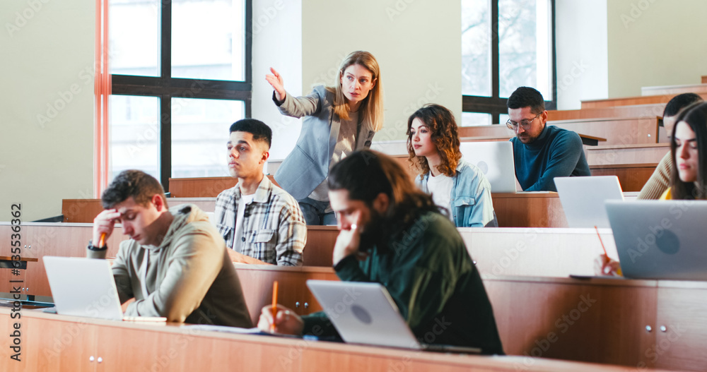Students sitting at lesson and studying. Inside. Female Caucasian ...