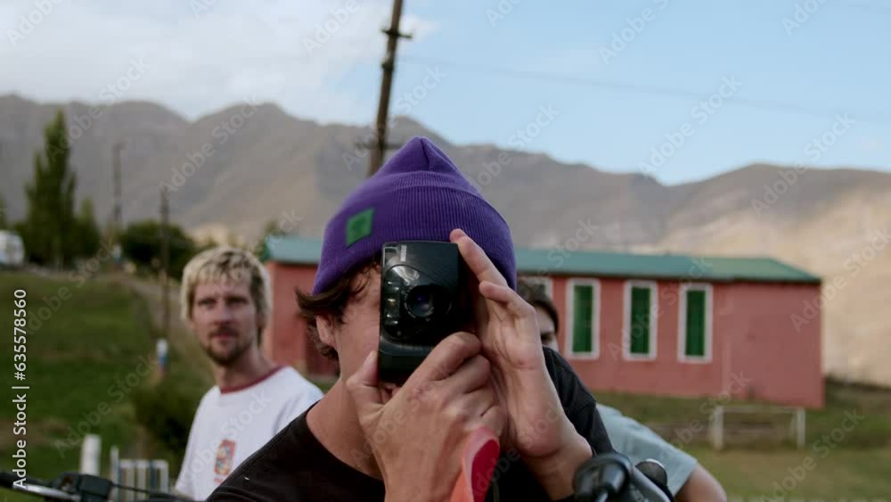 A young hipster man captures moments with an air of nostalgia ...