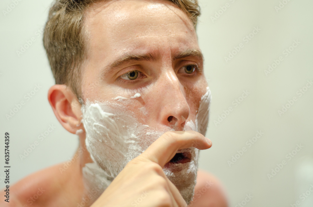 Caucasian man thinking about growing a mustache to support Movember ...