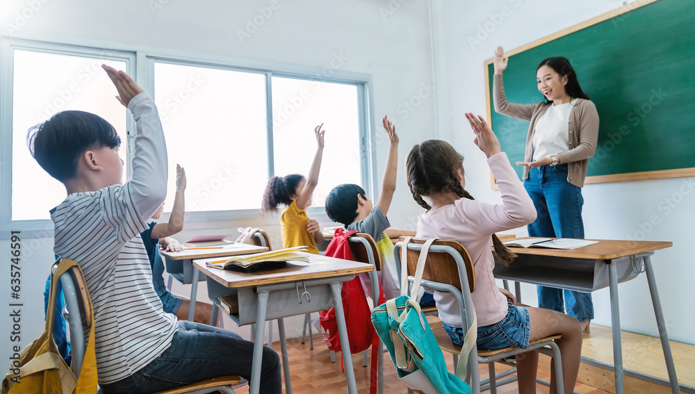 Multicultural group of students raising hands in class on lecture ...