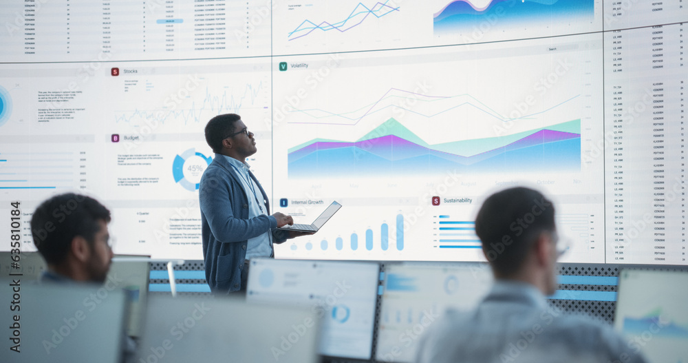 Male Financial Data Analyst Using Laptop And Studying Information And ...