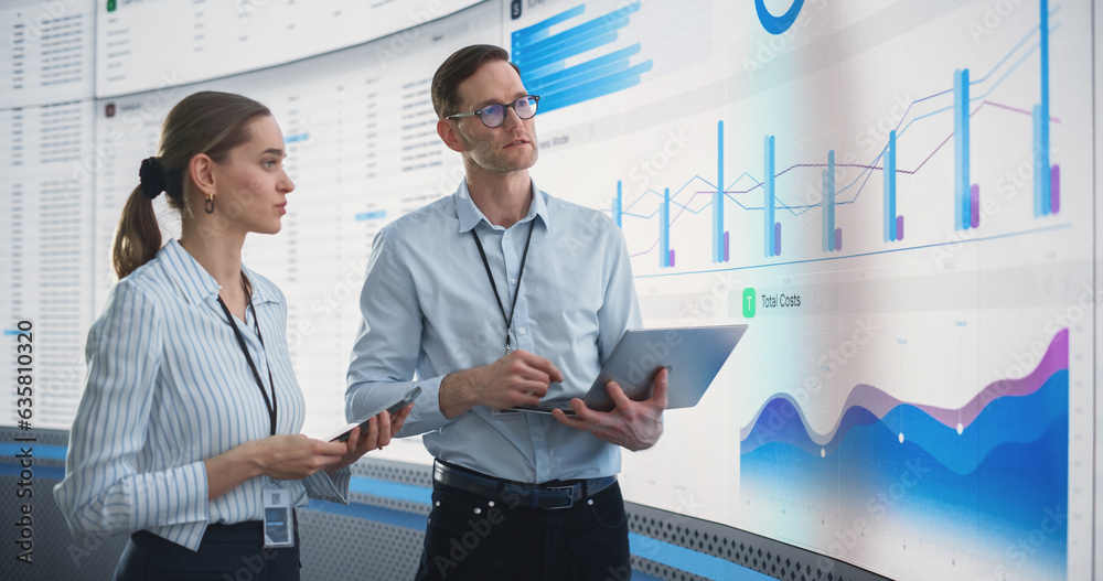 Male And Female Data Analysts Discussing New Locations For Business In ...