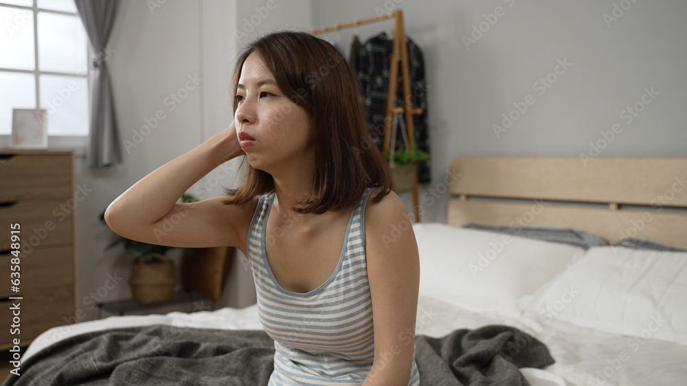Sleepy asian woman feeling drowsy and dizzy after waking up in bed in morning. tired female ...