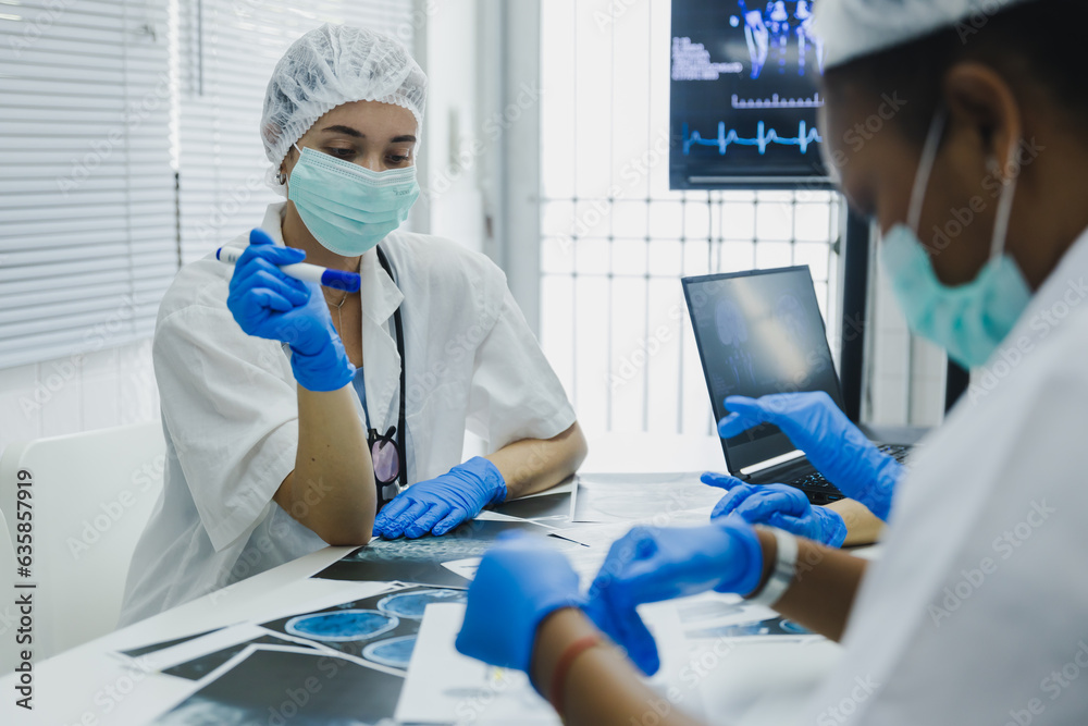 Team of female doctor check on scan results paper and looking at ...