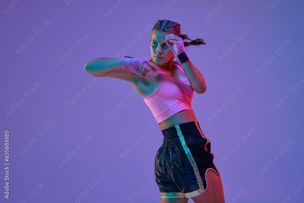 Defendeign and hitting. Teen girl, MMA fighter in motion, training ...