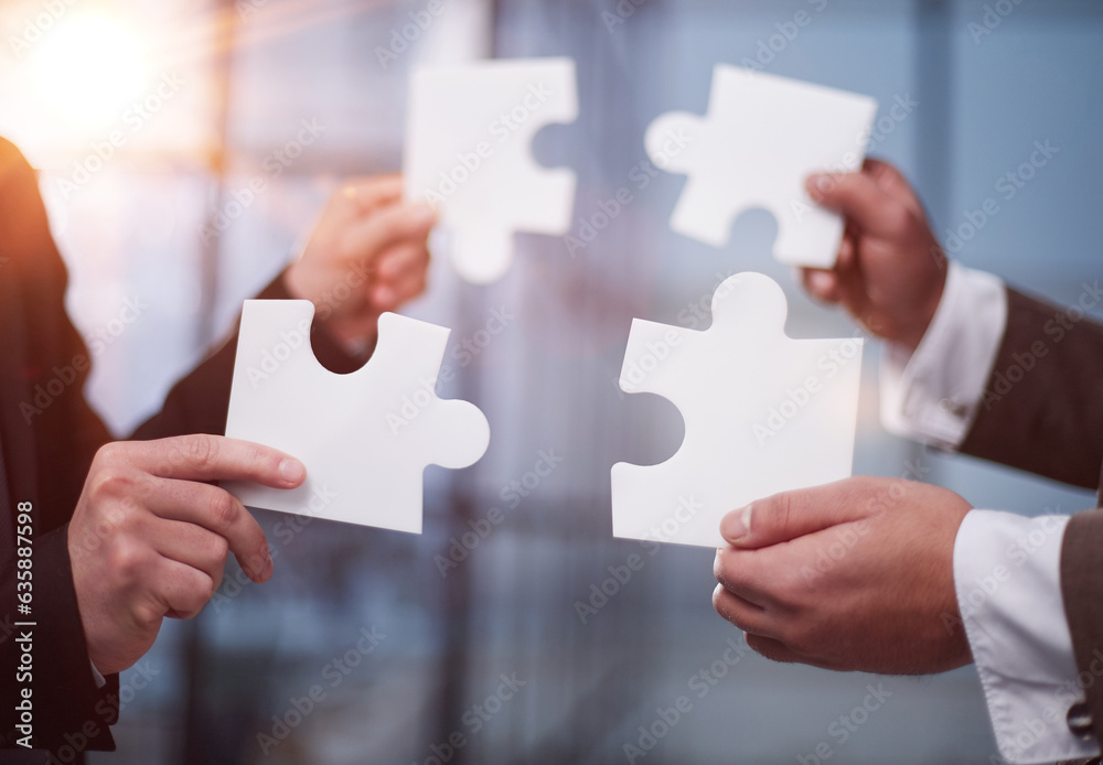 Working together to put things together. two unrecognizable ...