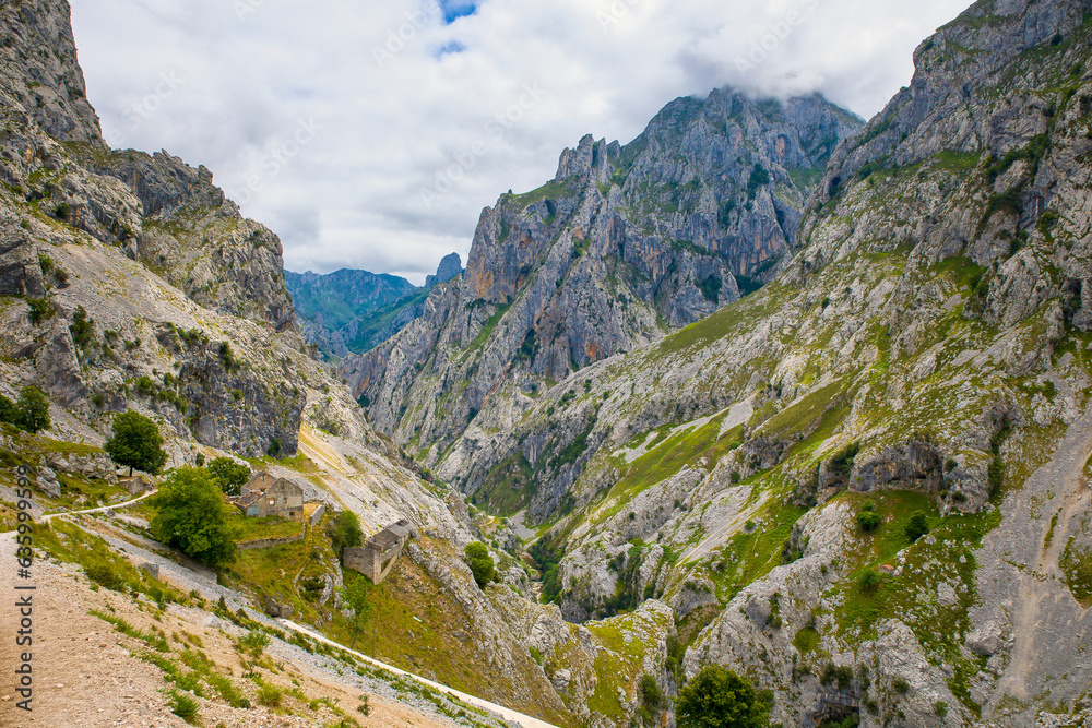 the narrow hiking trail winding along the rock face in the ruta del ...