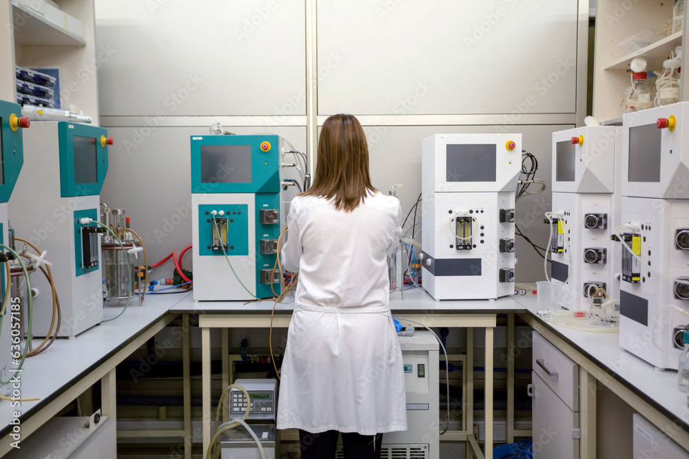 Woman in white lab coat on her back in the laboratory Stock Photo ...