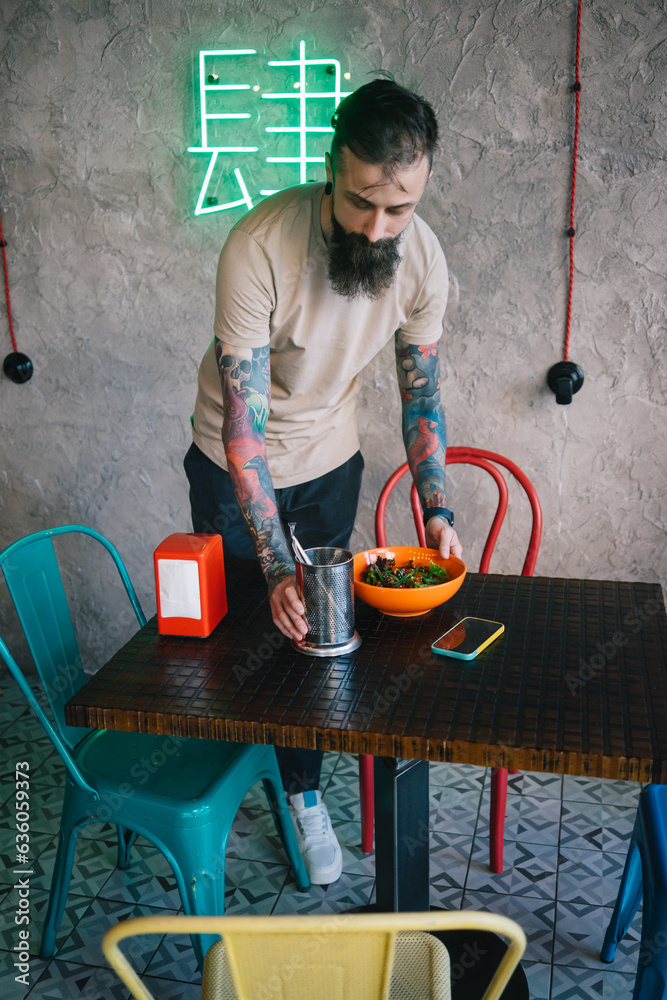 Man sit down at the table in an asian restaurant Stock Photo | Adobe Stock