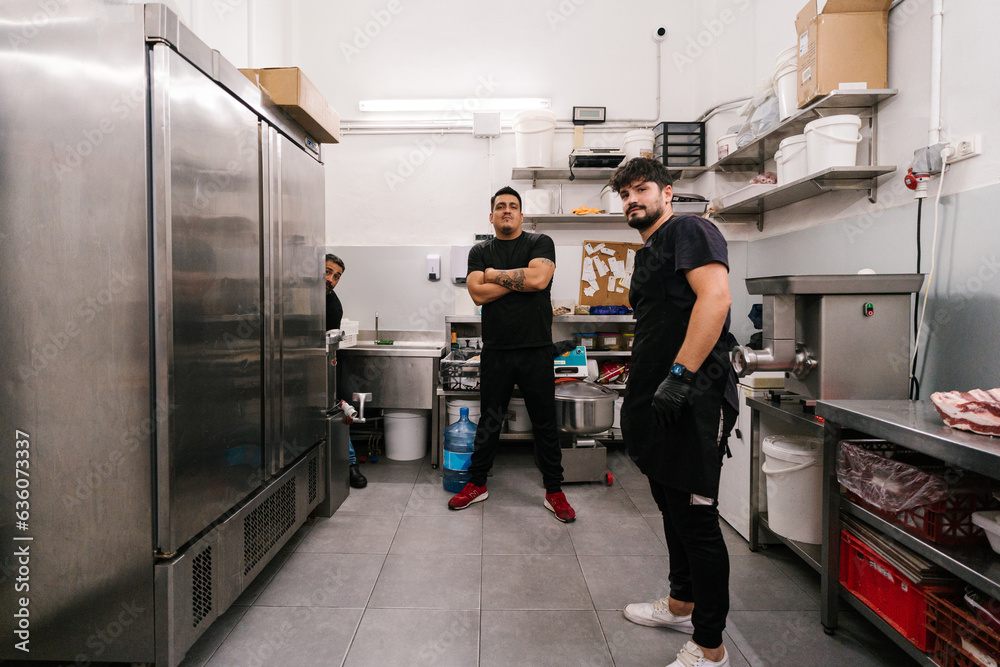 Young guys standing in kitchen in butchery Stock Photo | Adobe Stock