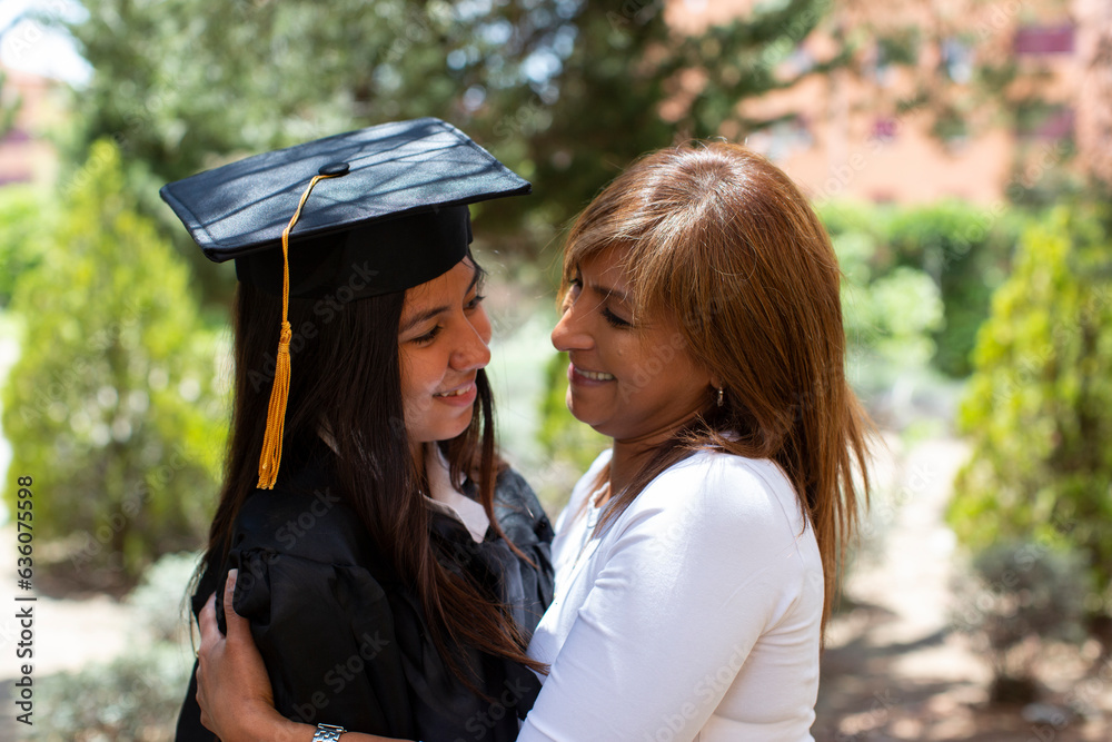 Teenage girl hugging her mother in graduation day Stock Photo | Adobe Stock