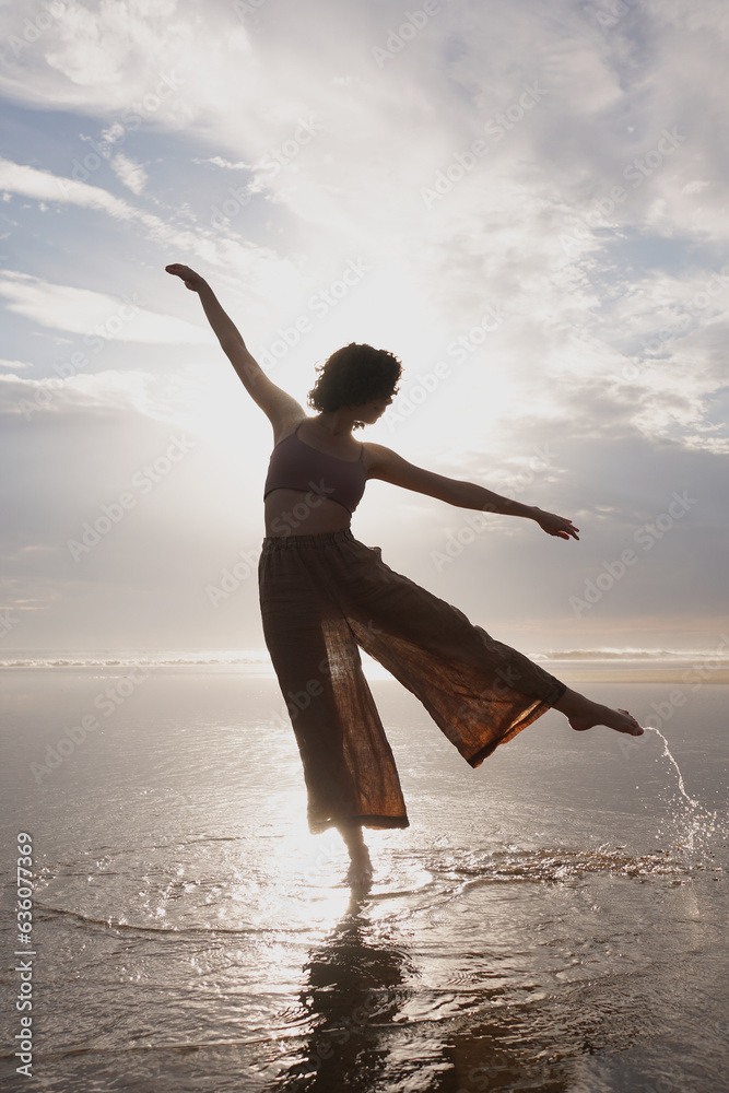 Young girl dancing on the shore of the Atlantic Ocean Stock Photo ...