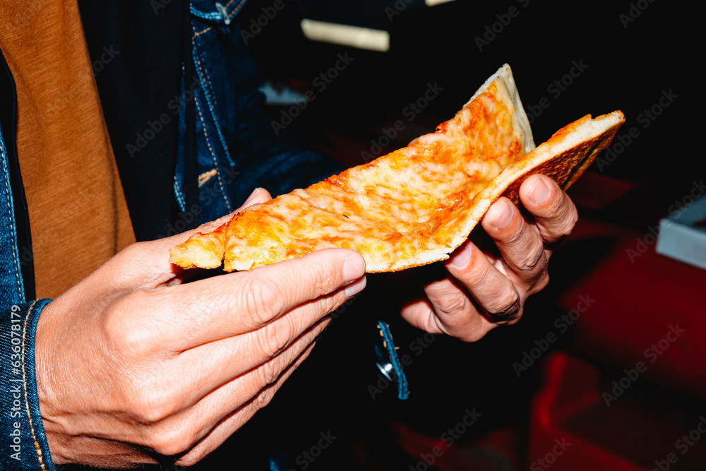 man about to eat a slice of cheese pizza Stock Photo | Adobe Stock