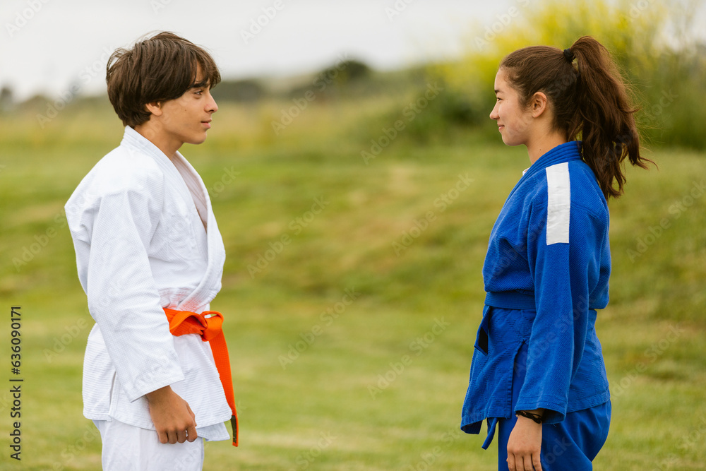 Diverse teenage judo couple in nature Stock Photo | Adobe Stock