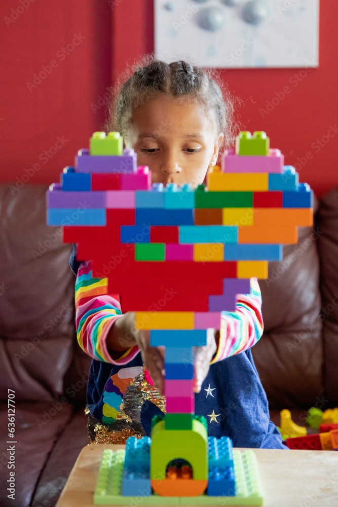 Child building a heart shaped structure with vibrant blocks Stock Photo ...