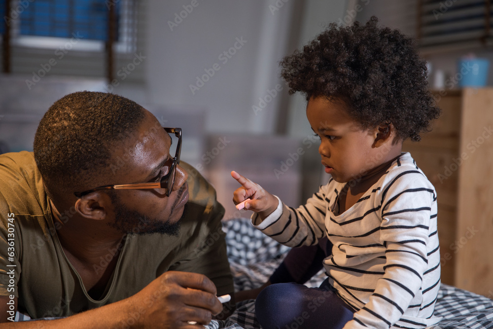 Father listening to his little son speaking while pointing finger Stock ...