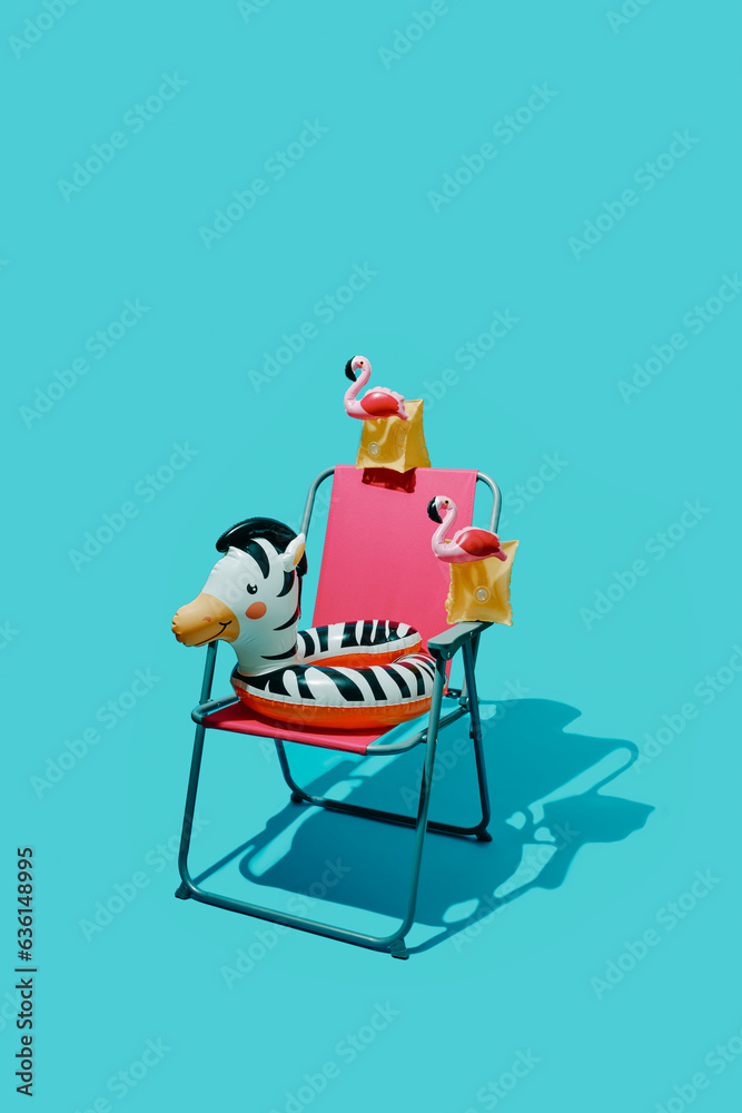 armbands and swim ring on a beach chair Stock Photo | Adobe Stock