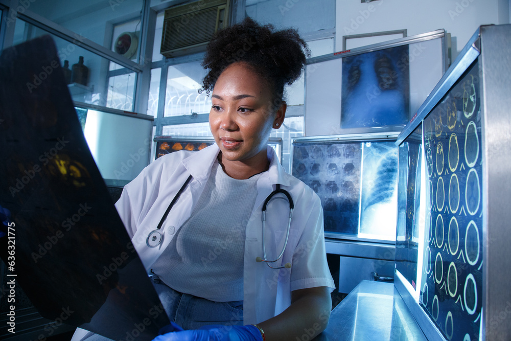 Female medical radiologist doctor looking head and brain x-ray film ...