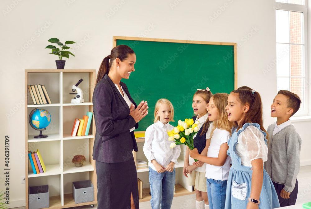 Teacher day. Children singing song congratulating happy teacher in ...