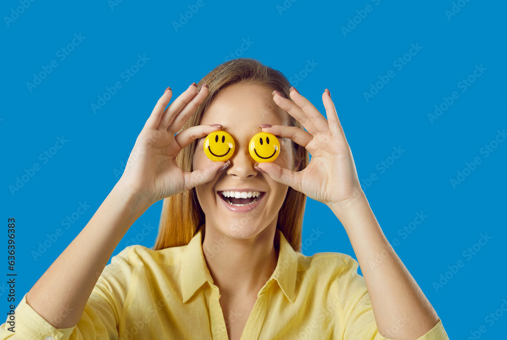 Portrait of overjoyed young woman isolated on blue studio background ...