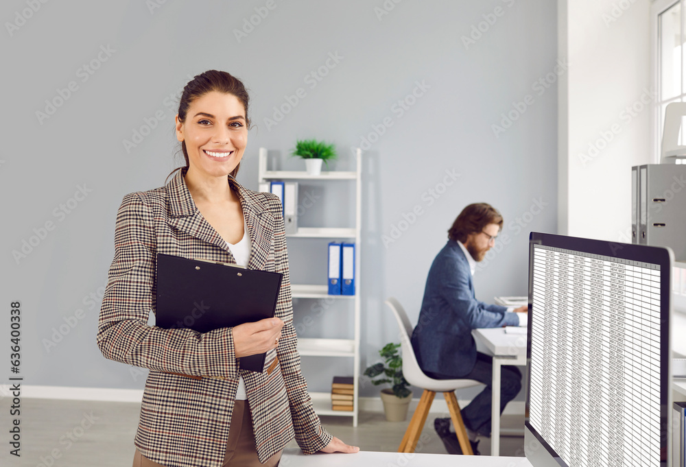 Portrait of friendly smiling female accountant or financial analyst at ...