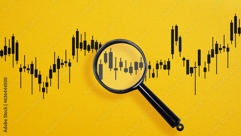 Insider trading. Stock market chart inside magnifier glass. Focus and ...