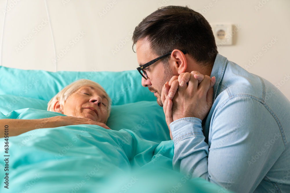Poster Anxious worried caring grandson holding hands of his sick ...
