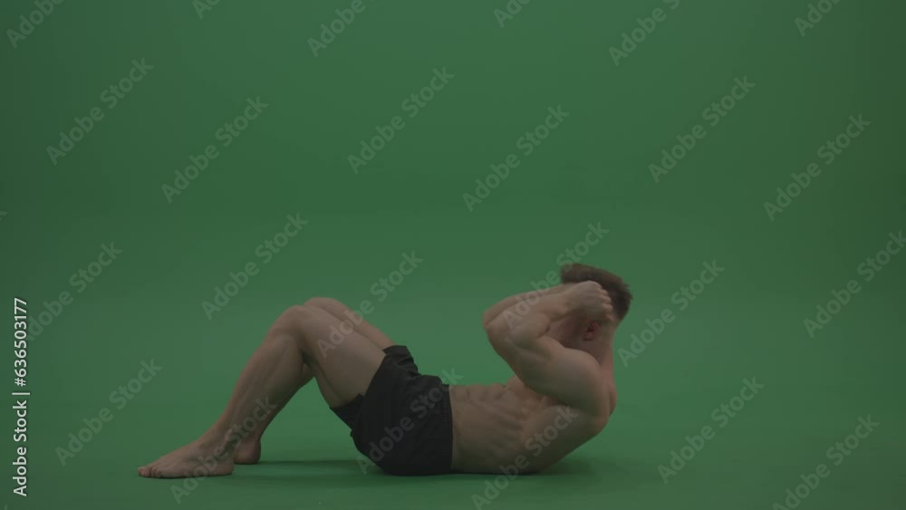 A young, bodybuilding athletic sportsman doing exercises for abdominal ...