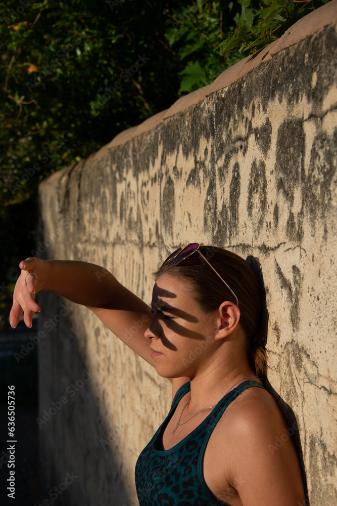 Beautiful woman holding her hand above her eyes, shielding face from ...