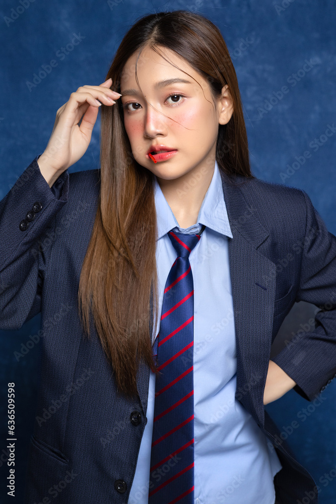 Beautiful Asian woman in school uniform taking a photo of yearbook ...