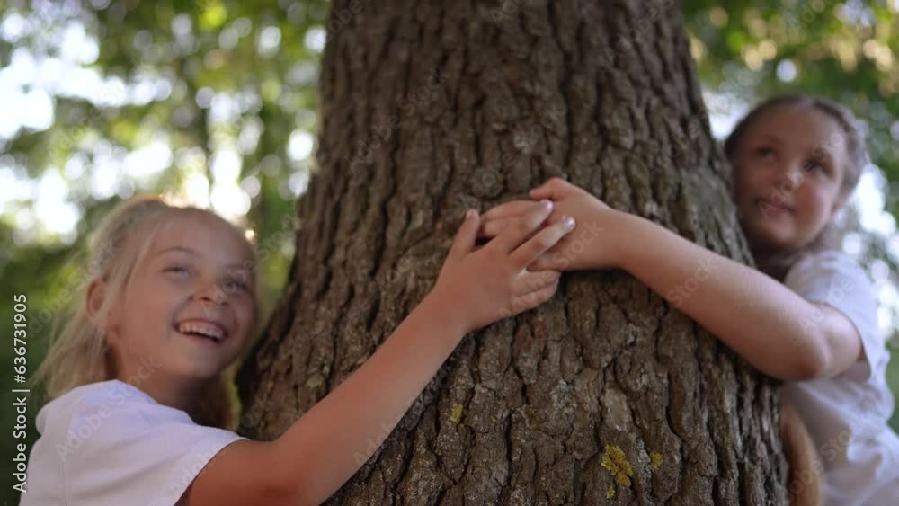 children hugging a tree in the forest. happy family childhood dream ...