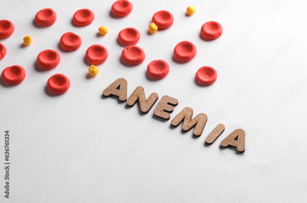Red blood cells model and word anemia on white background. Blood ...
