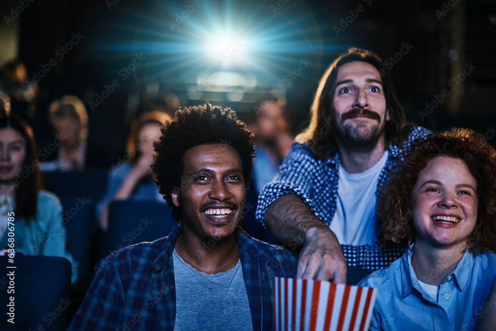 Young diverse group of friends watching a movie together in the movie ...