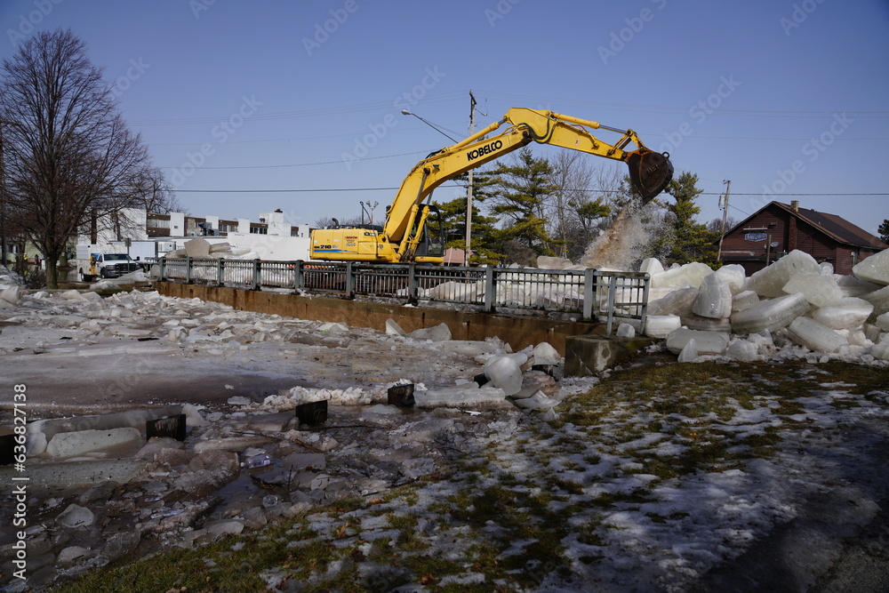 Fond du Lac city construction workers using Excavators to pull giant ...