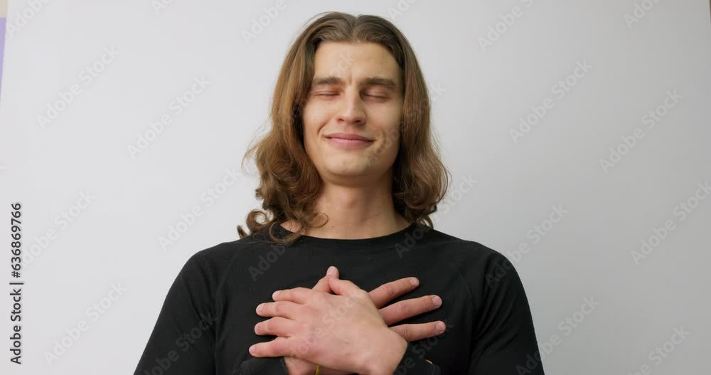 friendly smiling man thanking, putting palms hands on chest, expressing ...